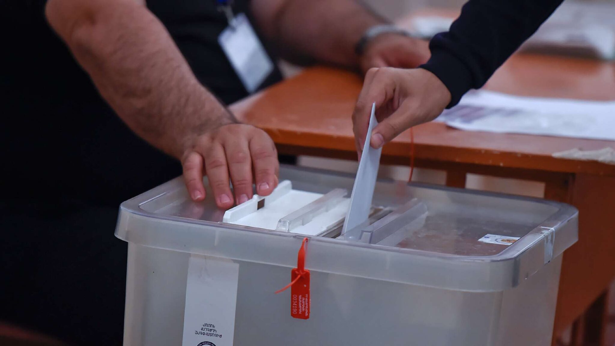 A police officer took the ballots out after voting at polling station ...
